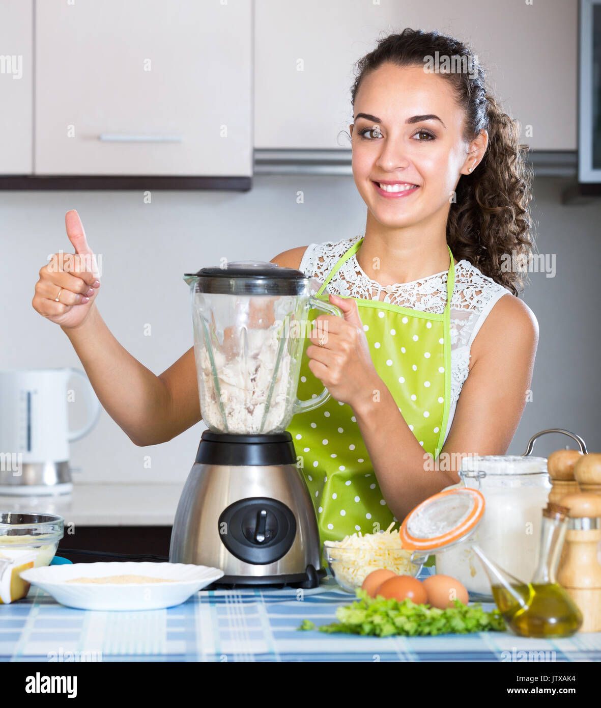 Happy girl using blender and grinding ingredients delicatessen Stock ...