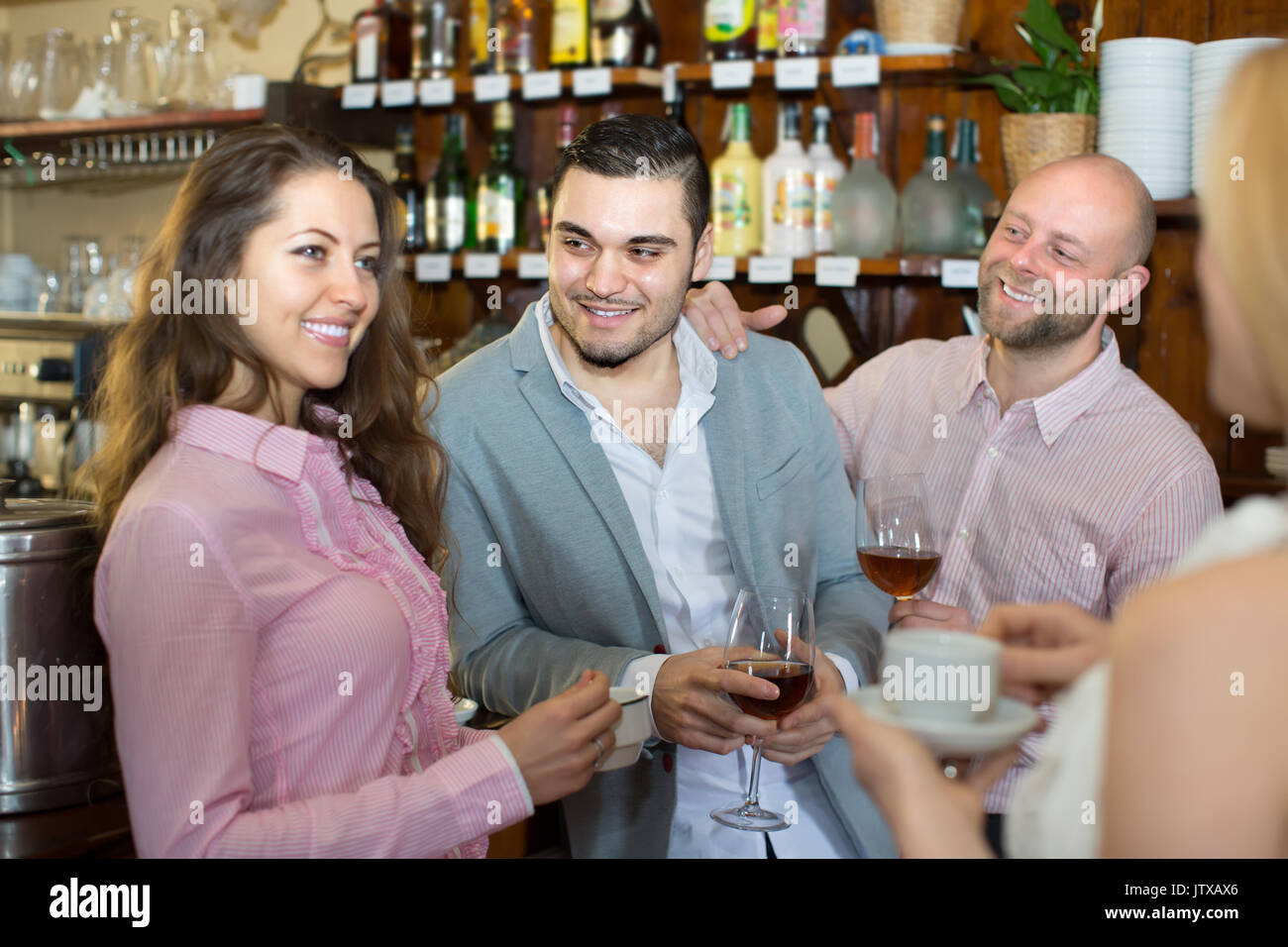 Group of cheerful young adults hanging out in bar. Focus on guy Stock ...