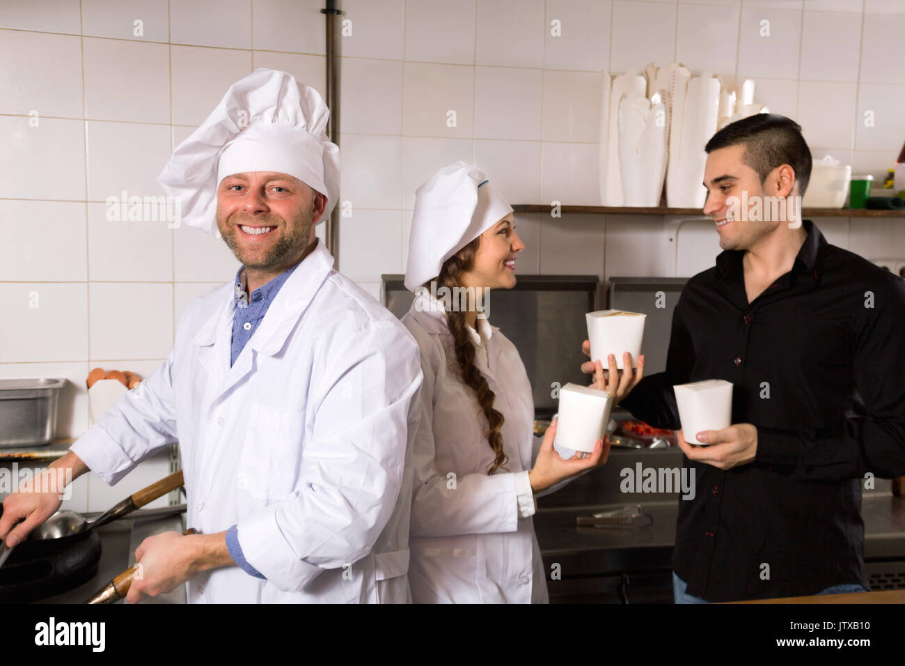 Positive customer, chef and cook at fastfood place Stock Photo - Alamy