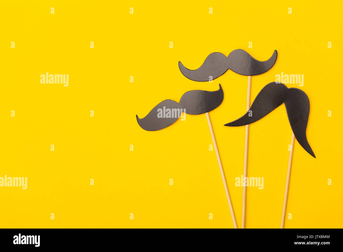 Moustache on a stick on a bright yellow background Stock Photo - Alamy