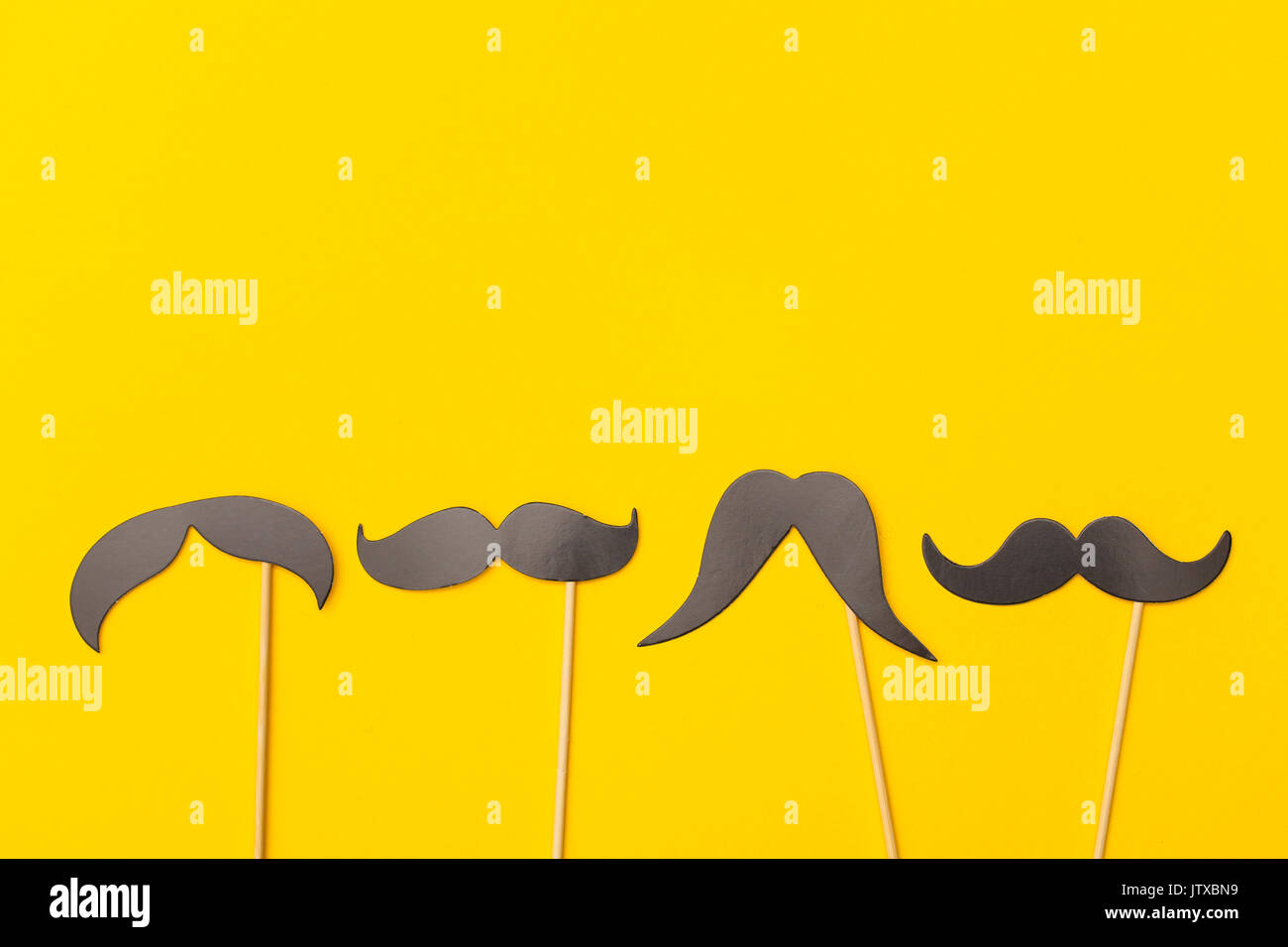 Moustache on a stick on a bright yellow background Stock Photo - Alamy