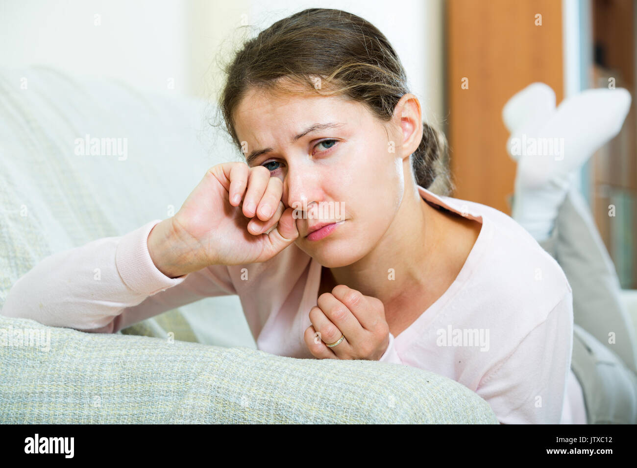 Portrait of sad housewife going through crisis in domestic interior ...