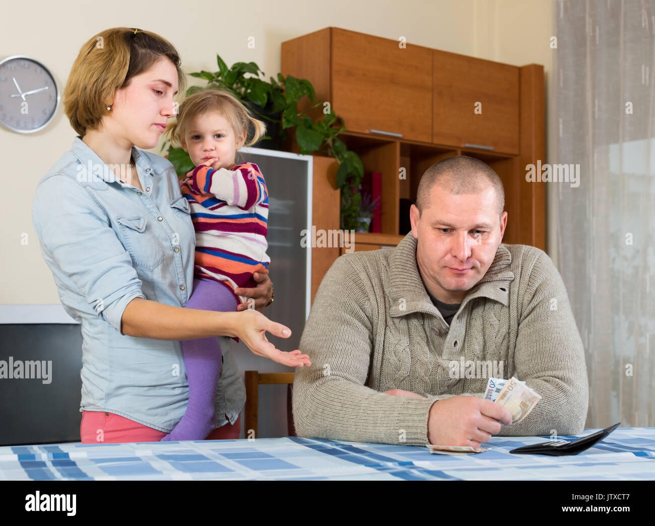 Financial problems in family. Sad woman wit child on hands against ...