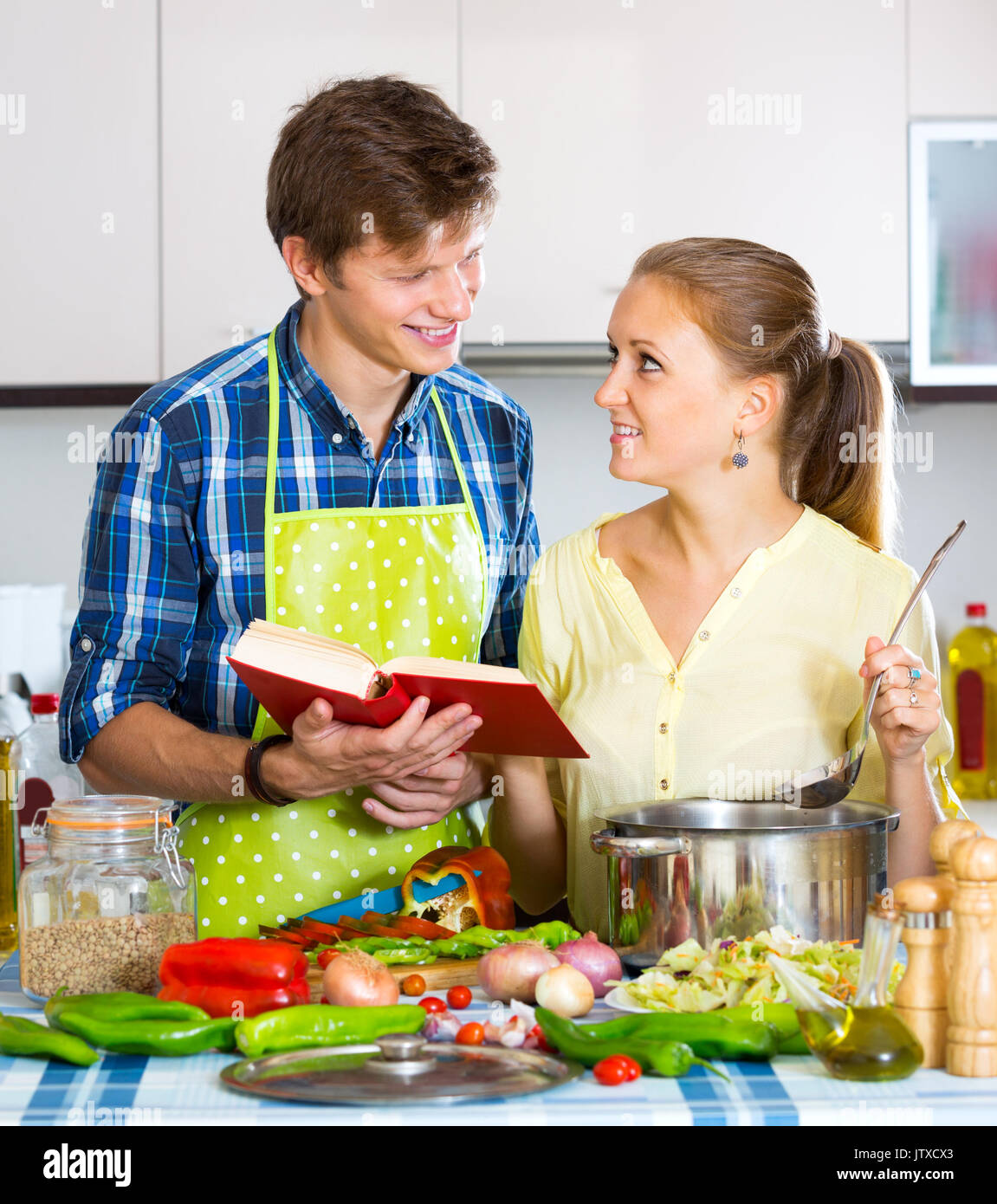 Cheerful young husband helping wife to prepare healthy dinner Stock ...