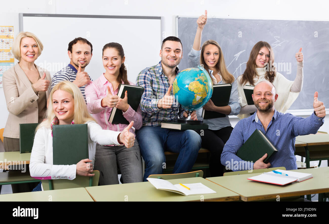 Happy cheerful smiling students and coach posing at training session ...