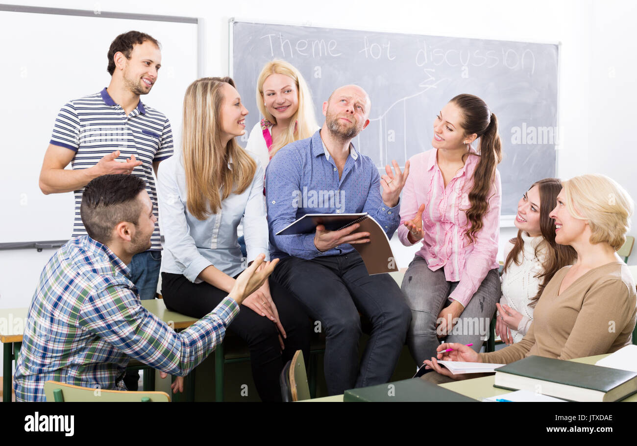 Teacher and cheerful students during break in classroom Stock Photo - Alamy