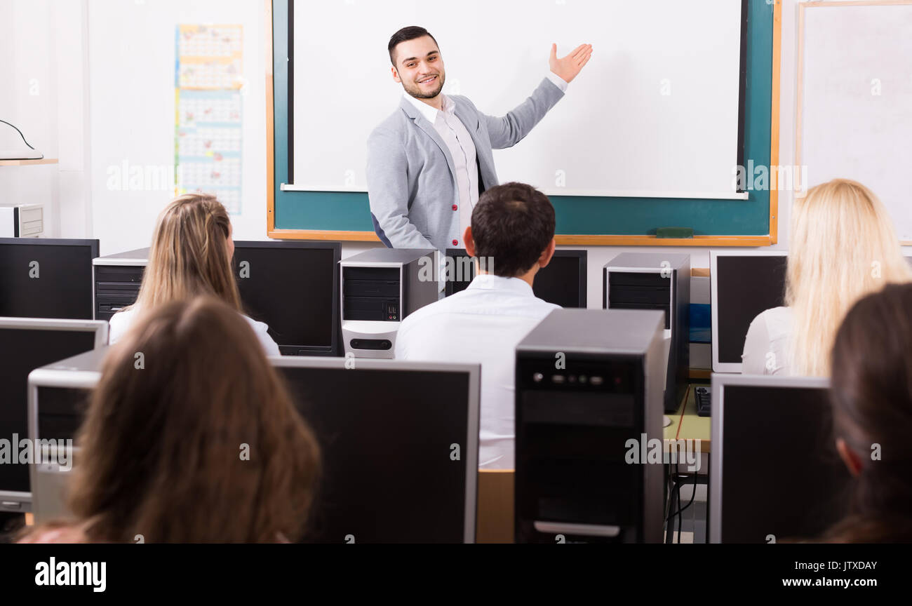 Manager and employees working with computers at office Stock Photo - Alamy