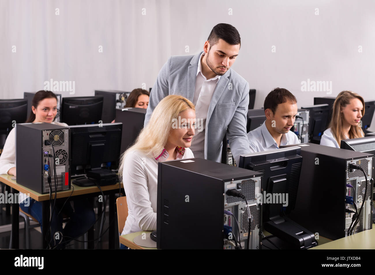 Successful supervisor of company giving instructions to office team ...