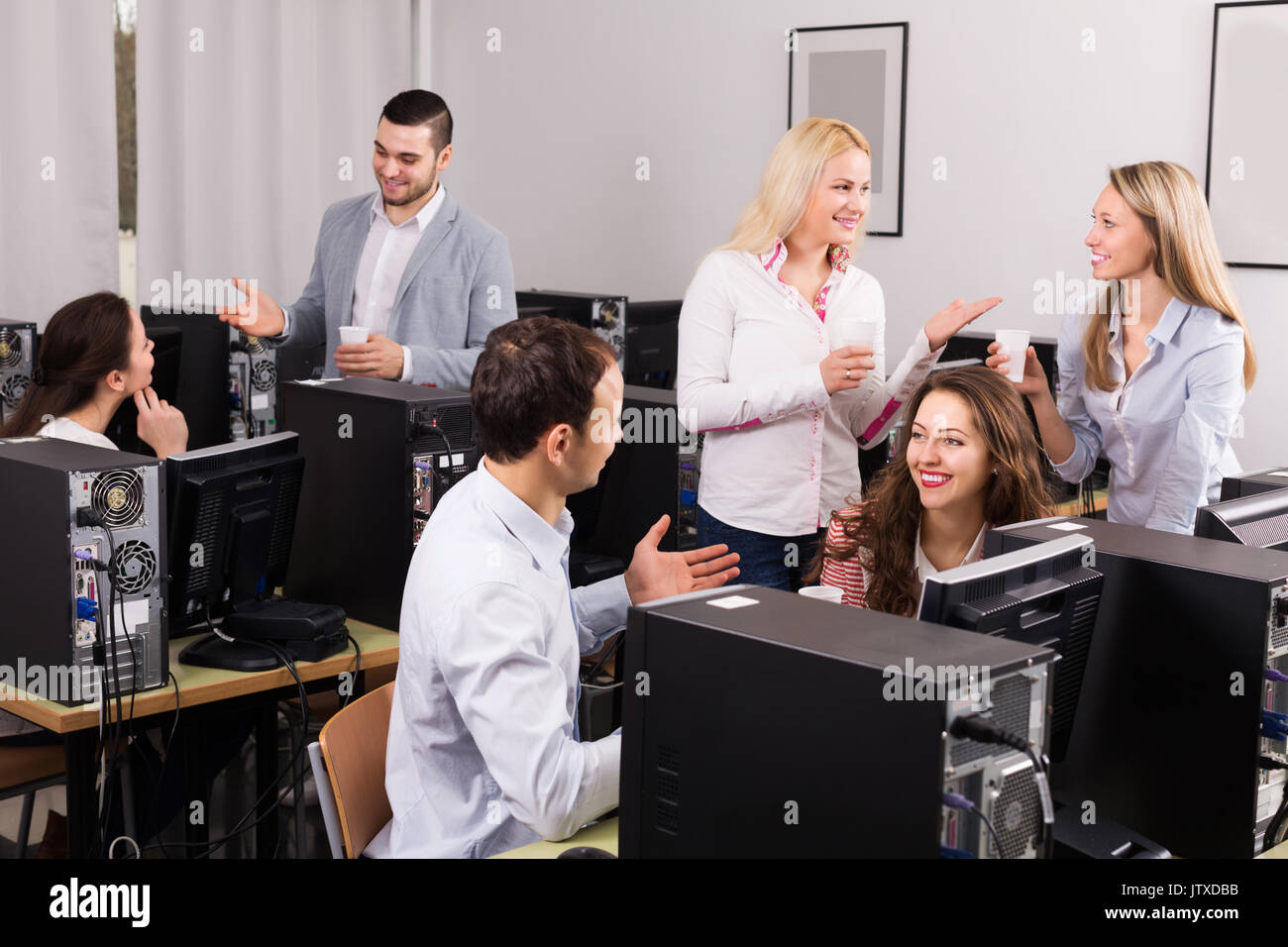 Happy employees and manager celebrating good dealing Stock Photo - Alamy