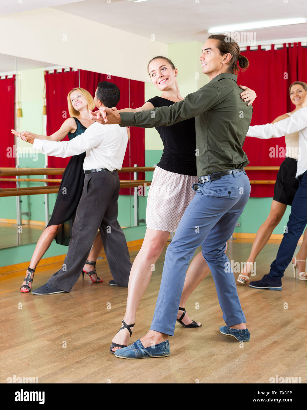 spanish men and women enjoying of tango in class Stock Photo - Alamy