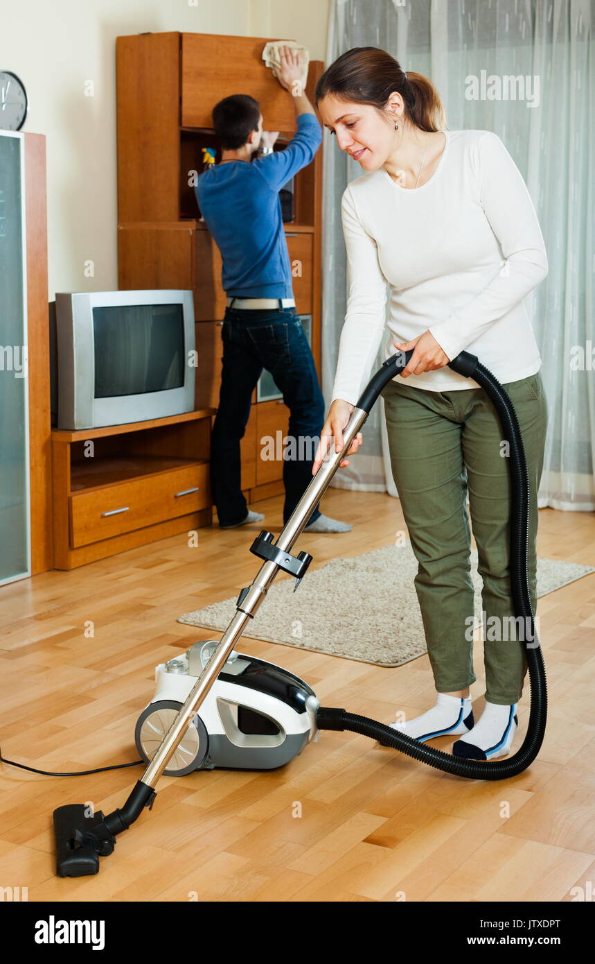 Handsome couple doing housework together in home Stock Photo - Alamy