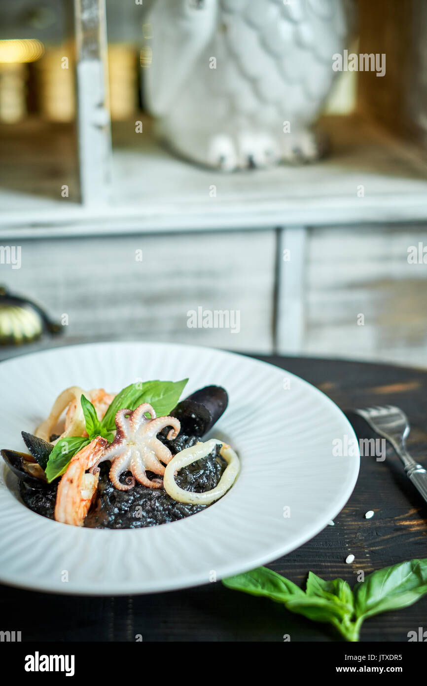 Dish of risotto with squid ink on grey plate jpg Stock Photo - Alamy