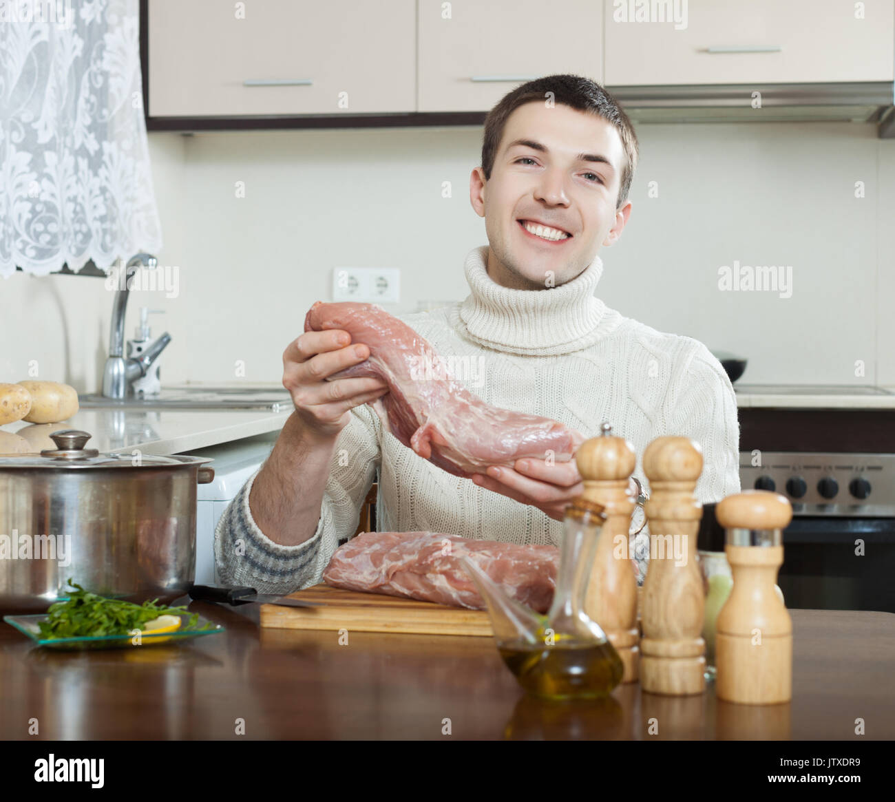 Smiling guy roasting meat in hi-res stock photography and images - Alamy