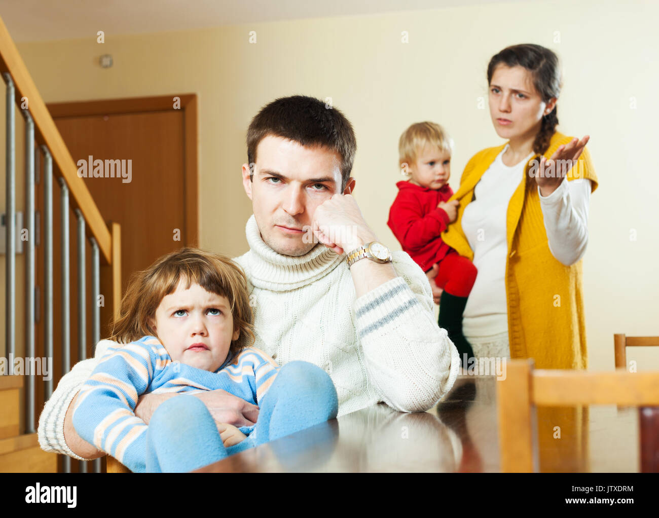 Couple with two children in quarrel at home Stock Photo - Alamy