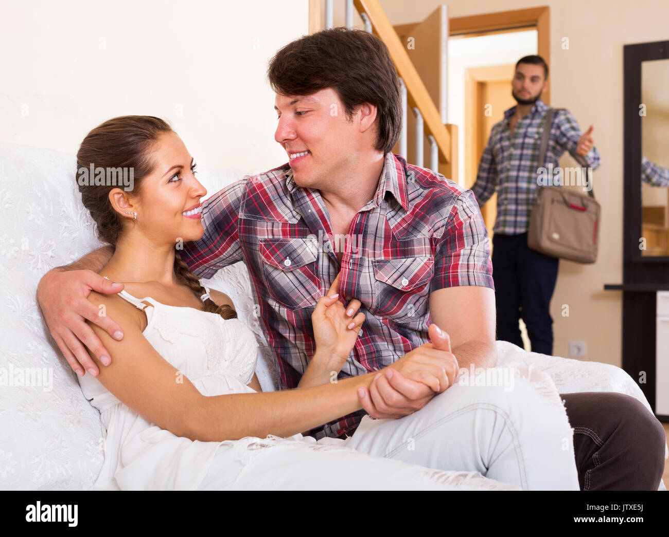 Surprised young husband coming home in wrong moment Stock Photo - Alamy