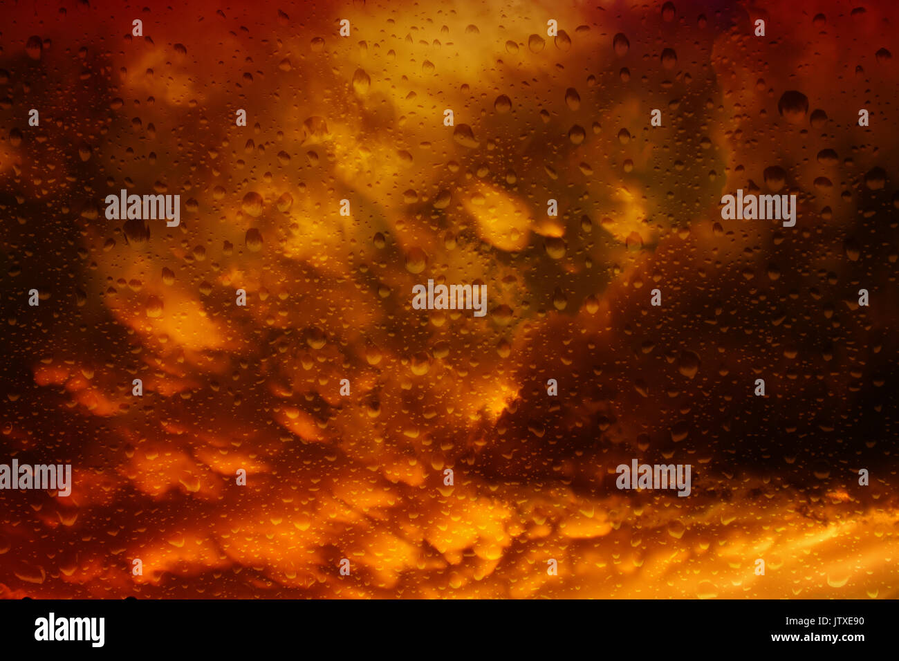 Looking through a misty window with raindrops at the dramatic storm ...