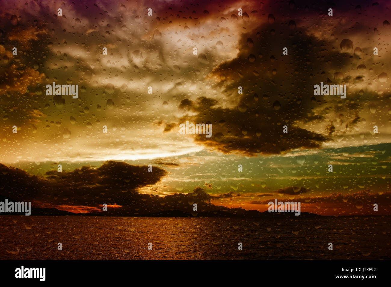 Looking through a misty window with raindrops at the dramatic storm ...