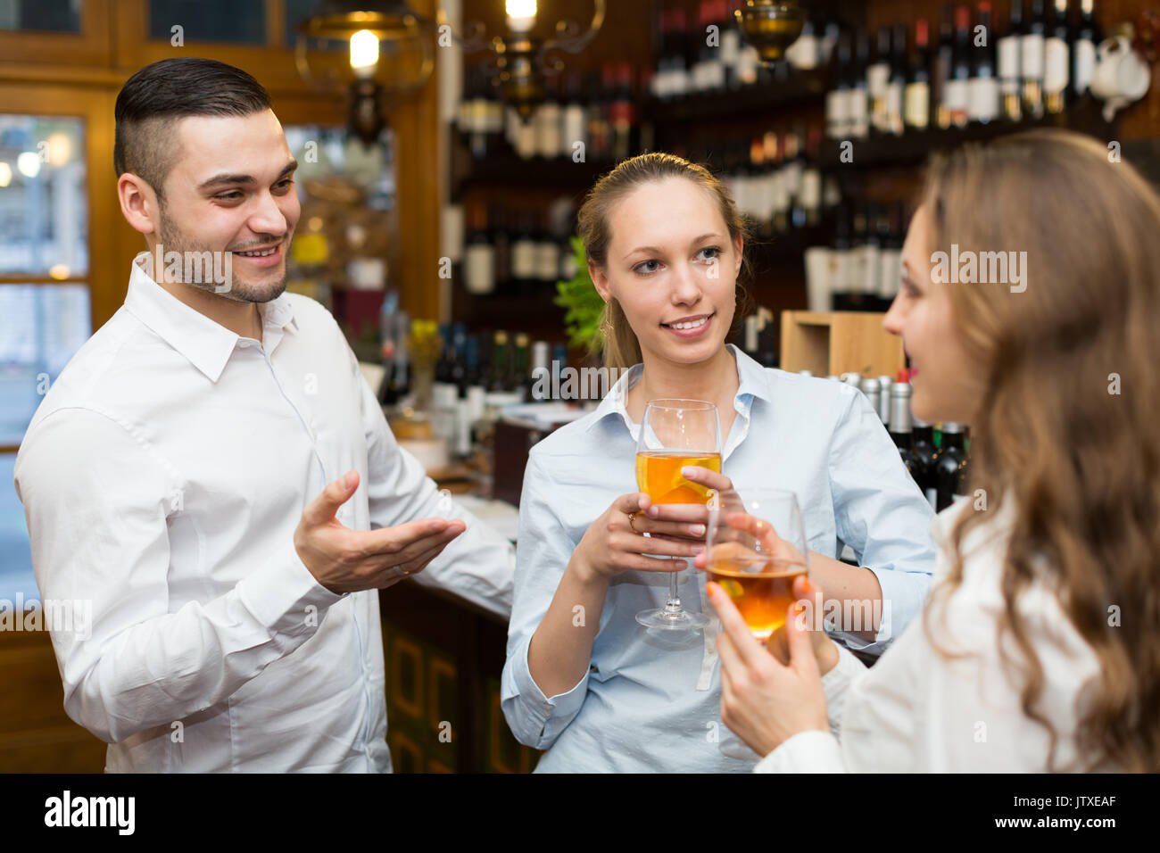 Restaurant guests waiting for table and having beverages in tavern ...