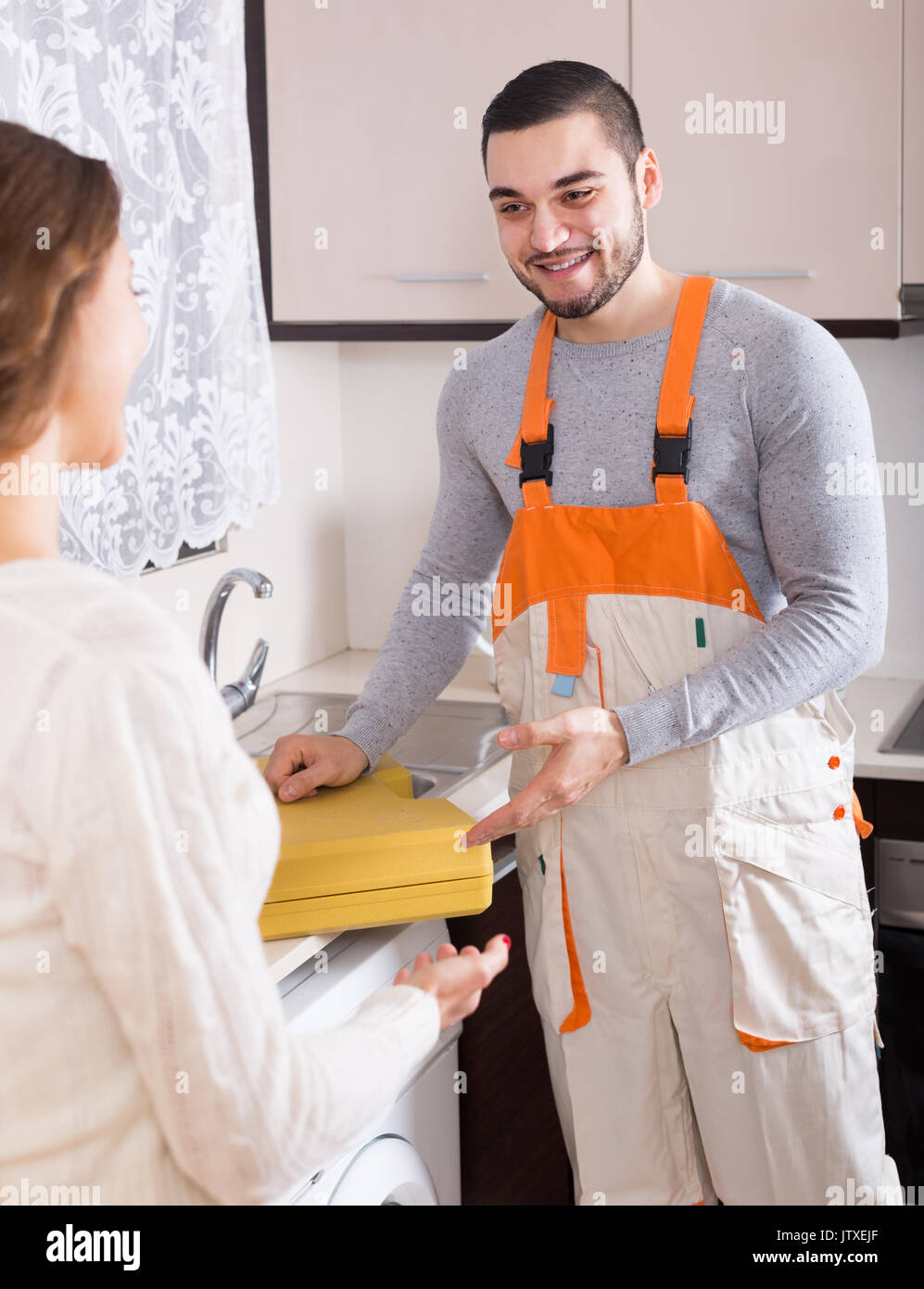 Professional plumber visiting customer for repairing water lines Stock ...