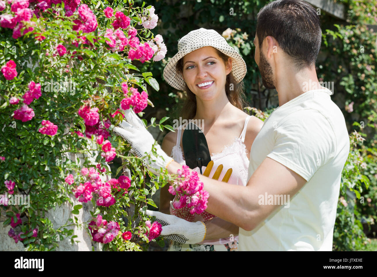 Happy family in garden flowers with horticultural sundry for planting ...