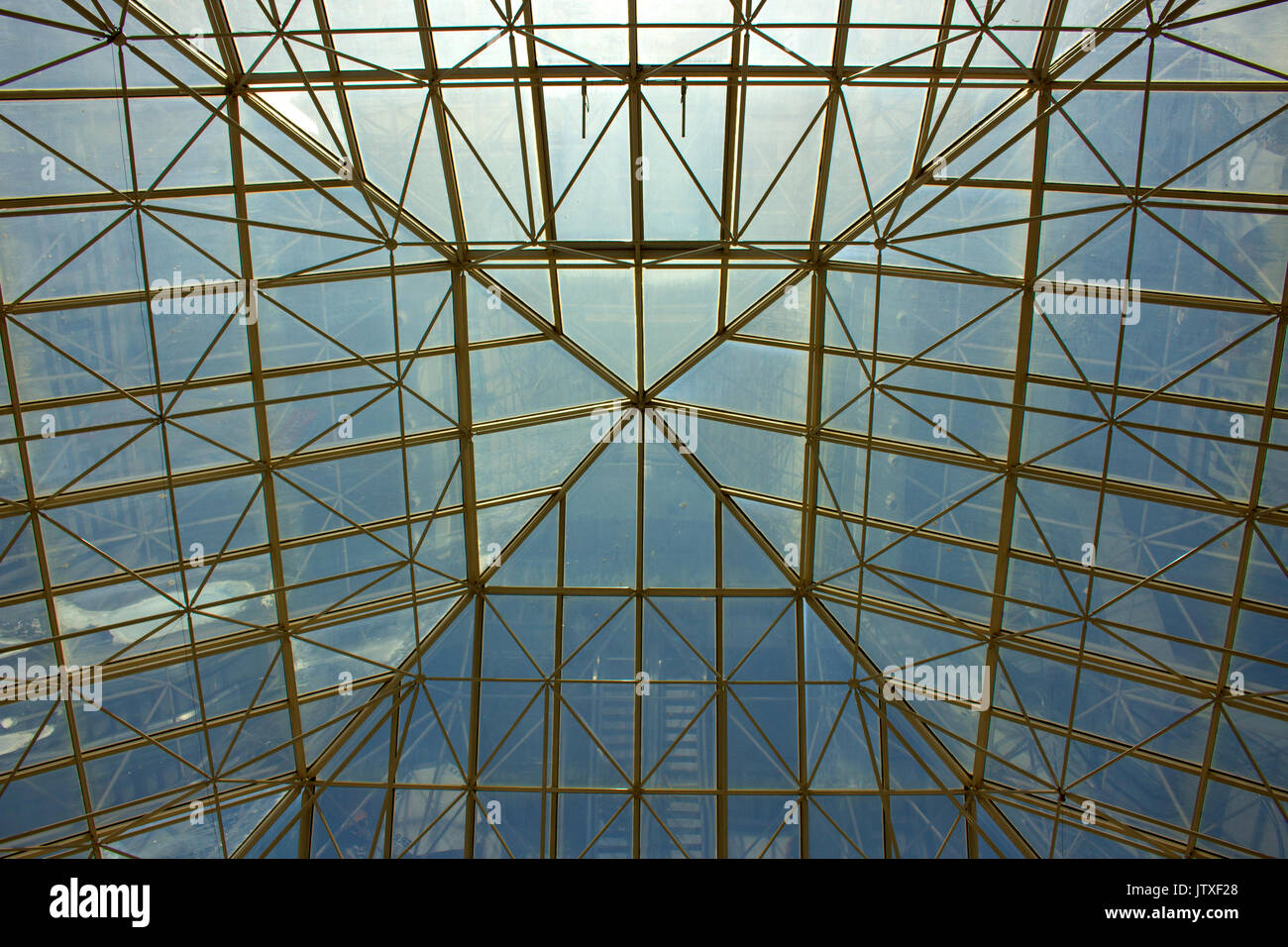 Glass roof. Pyramid construction. Modern architecture. Sky and clouds ...