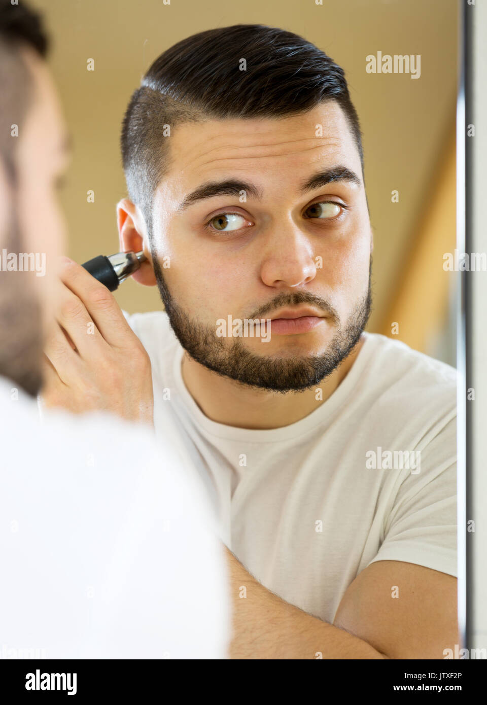 portrait handsome man trims nose and ears hair at home Stock Photo - Alamy