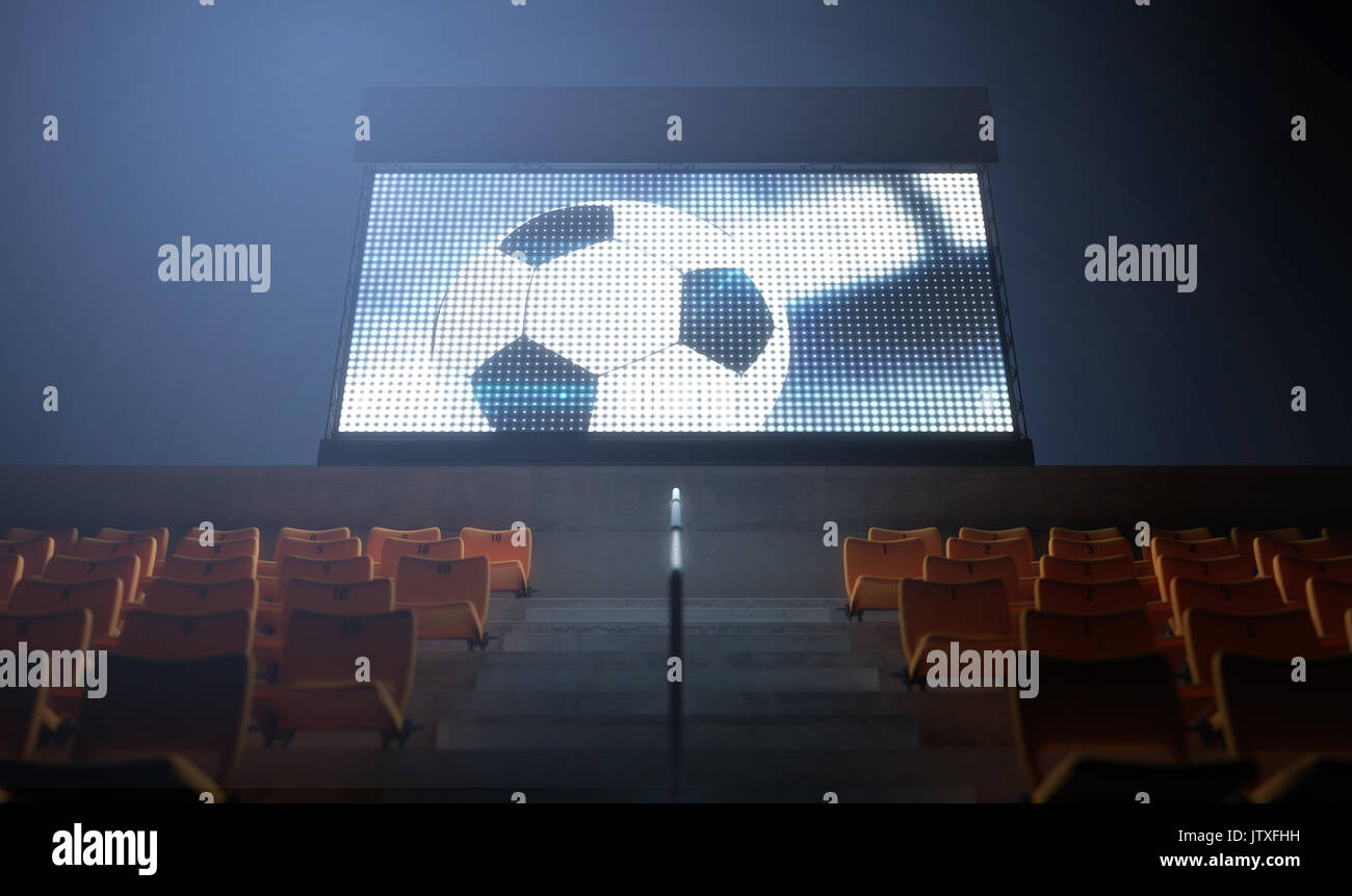An illuminated stadium big screen showing a soccer replay in the stands ...