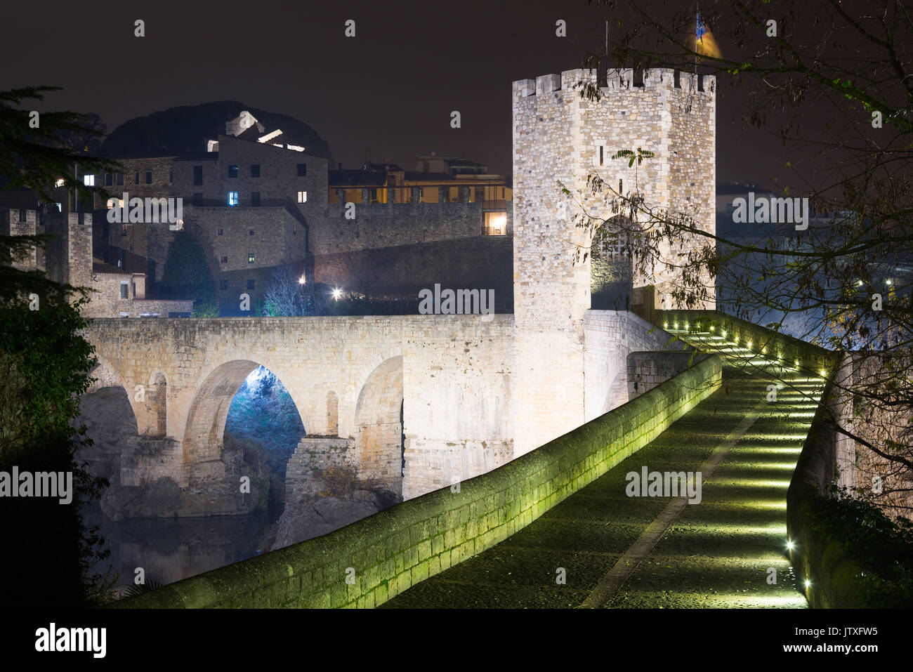 night photo of old medieval stone bridge with gate, built in 12th ...