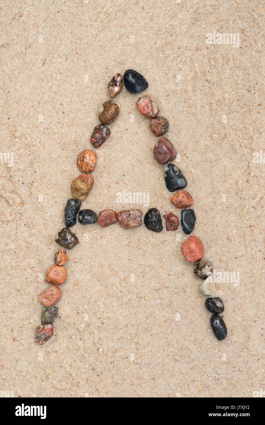 Alphabet writing on sand letter hi-res stock photography and images - Alamy