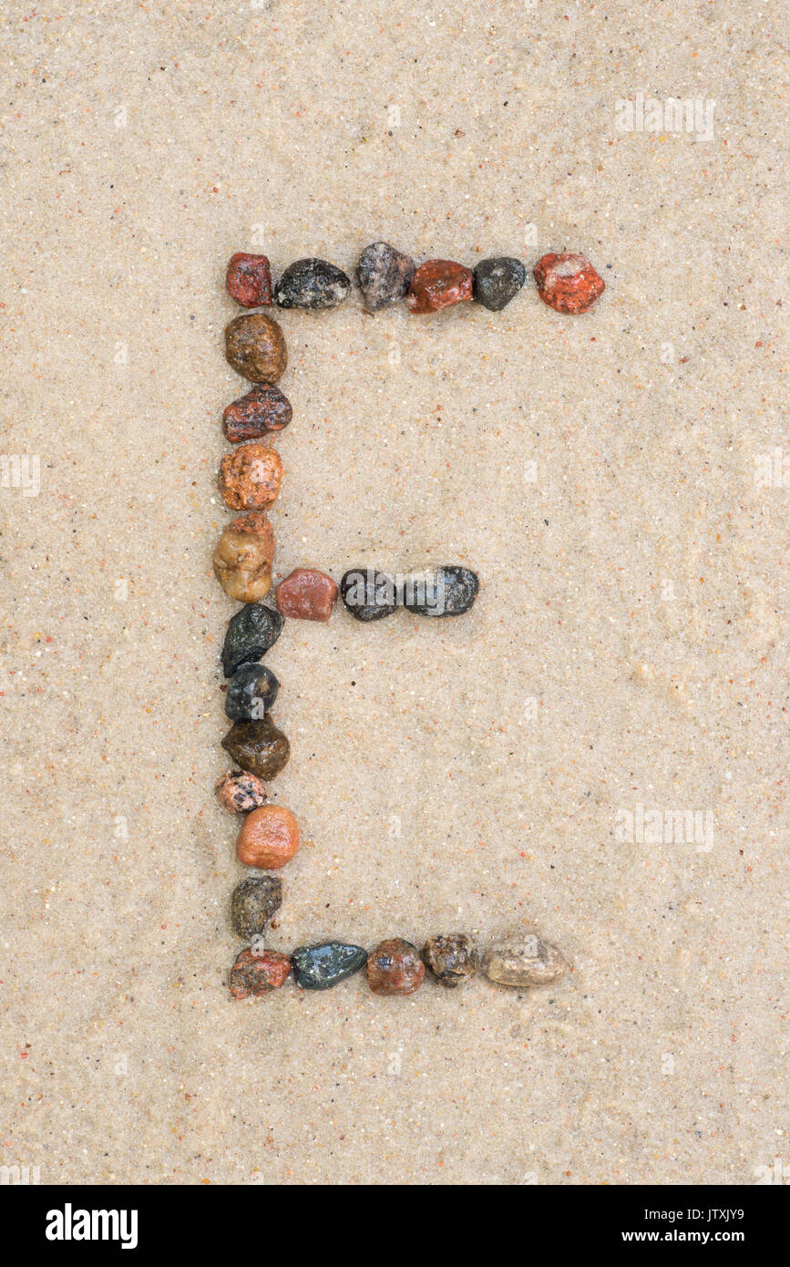 Alphabet writing on sand letter hi-res stock photography and images - Alamy