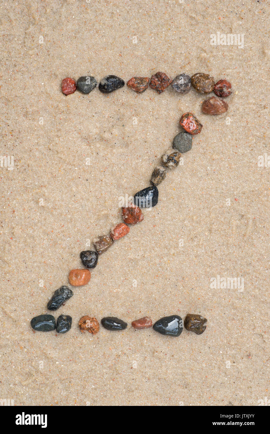 pebble z letter on sand background Stock Photo - Alamy