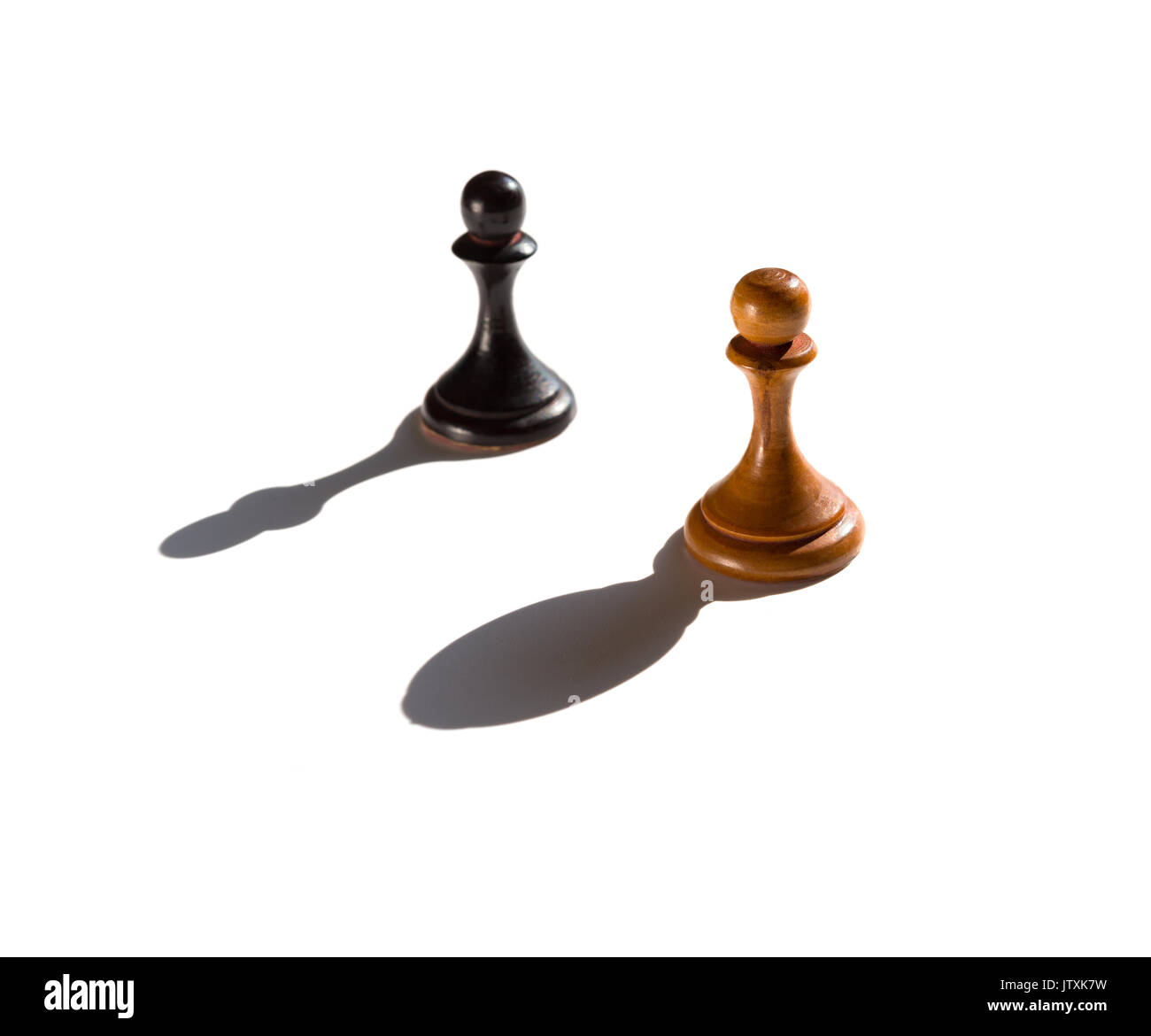 two chess pawns one casting a bishop piece shadow concept of strength ...