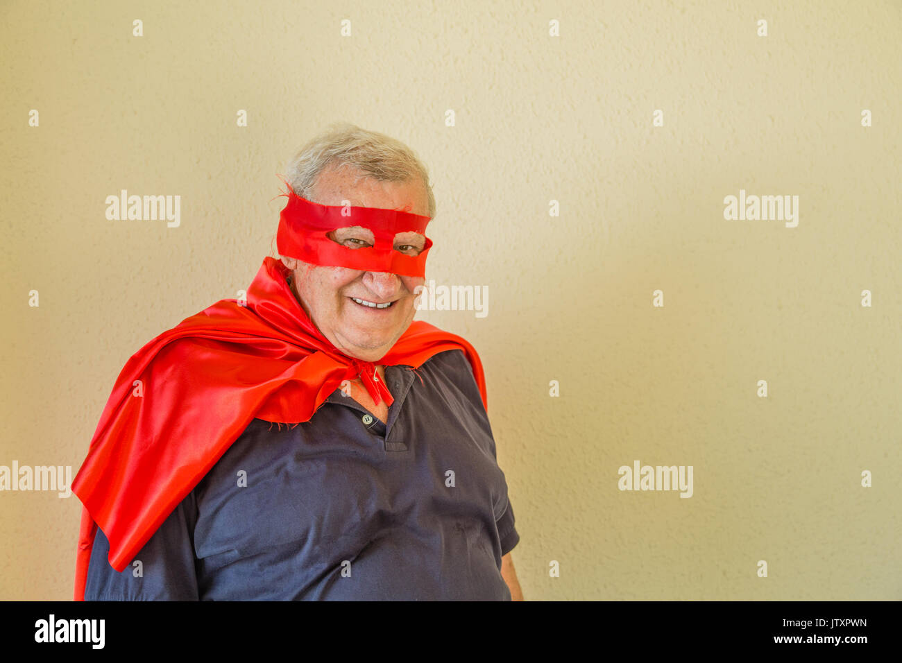 smiling old man dressed as fun superhero Stock Photo - Alamy