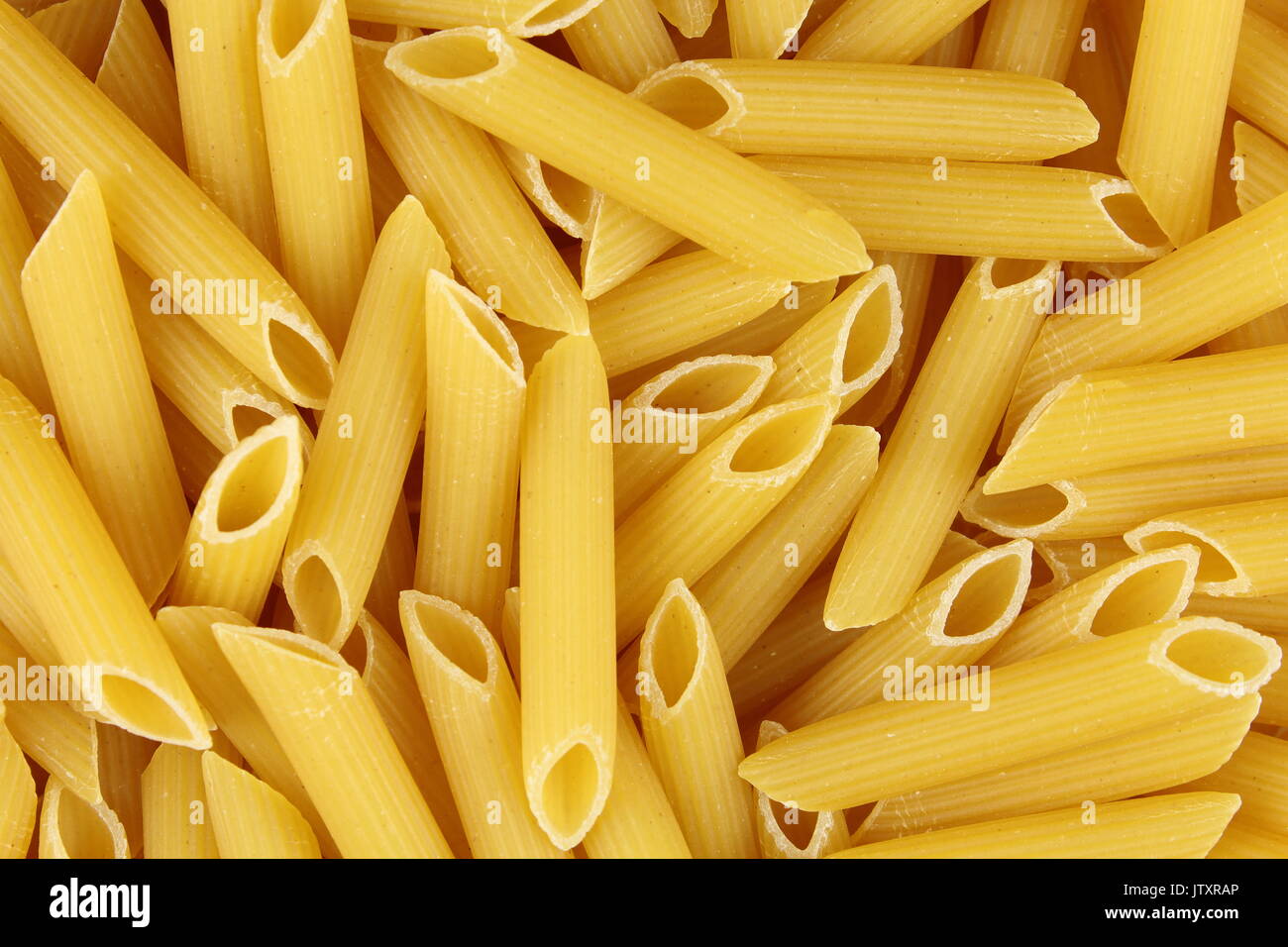 uncooked penne rigate pasta closeup as a food background texture Stock ...