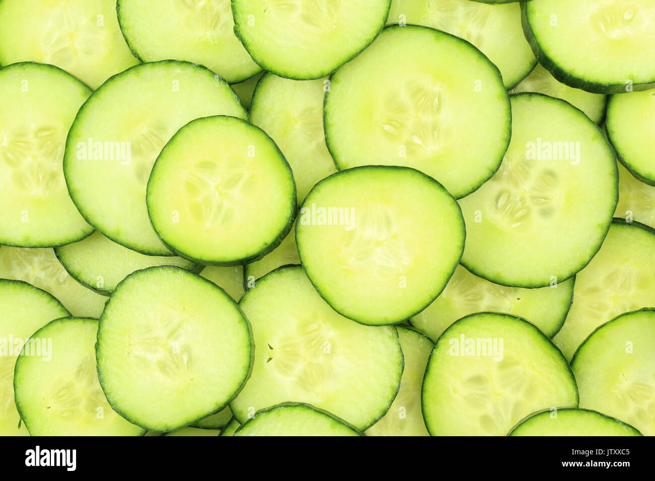 slices of fresh green cucumbers as a food background texture Stock ...