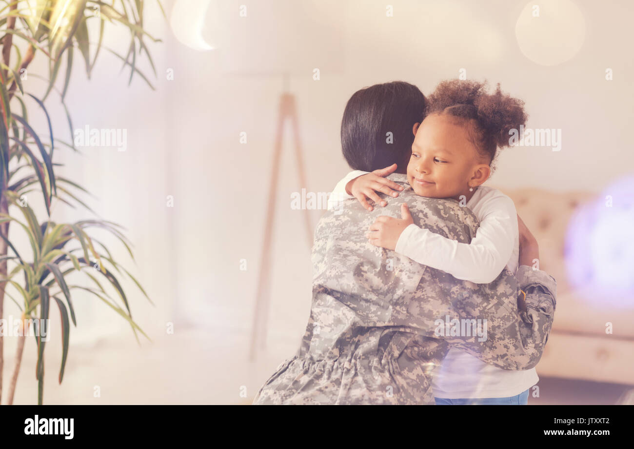 Happy daughter hugging her mother-soldier Stock Photo - Alamy