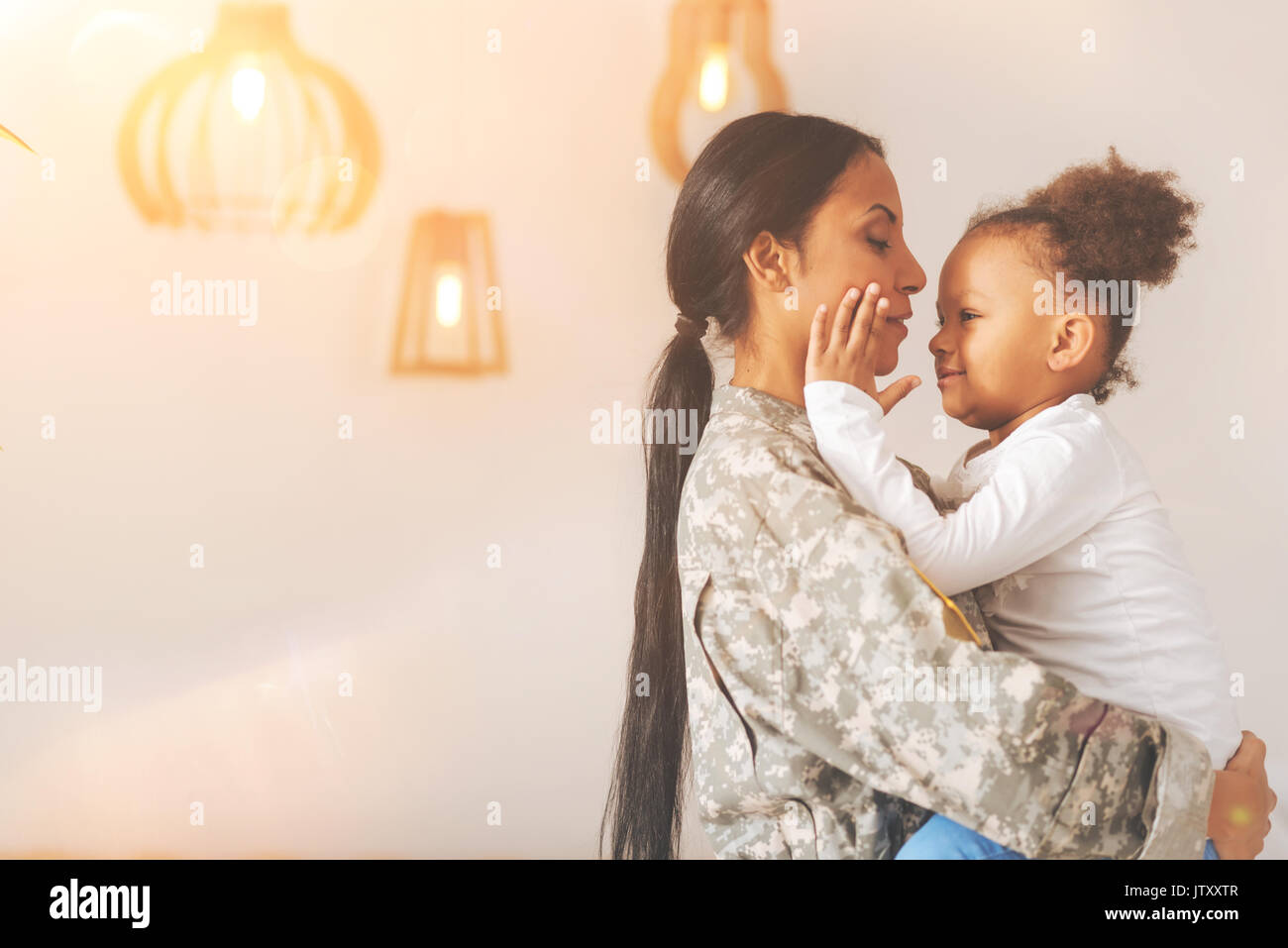 Adorable little girl touching cheeks of her mother Stock Photo - Alamy