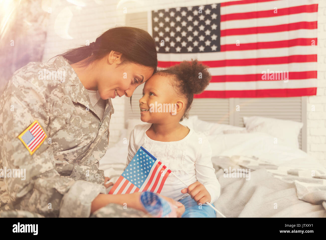 Adorable mother and daughter leaning forehead to forehead Stock Photo ...