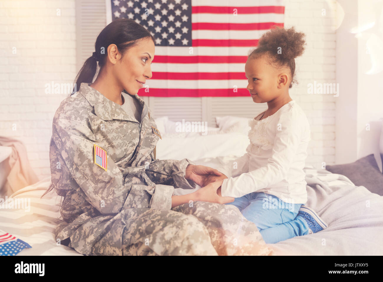 Military mother holding her daughters hands Stock Photo - Alamy