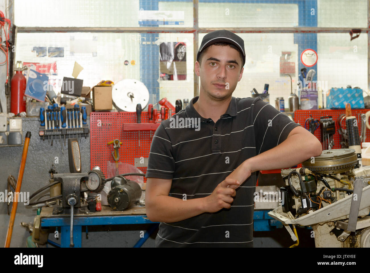 a portrait of a young mechanic in his workshop Stock Photo - Alamy