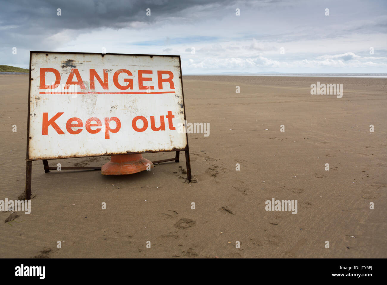 Danger Keep Out sign on empty beach warning of weapons testing on ...