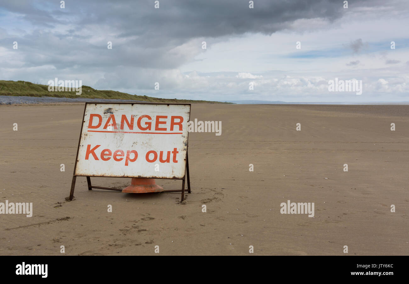 Danger Keep Out sign on empty beach warning of weapons testing on ...