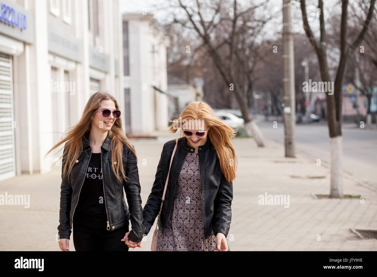 Two friends hanging out in the city Stock Photo - Alamy