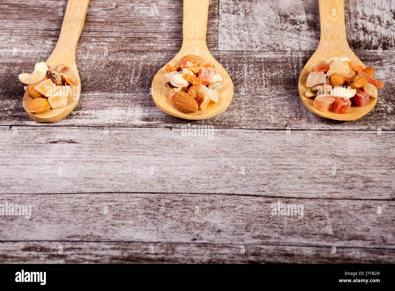 Wooden spoon with Healthy different type of nuts and sweet Stock Photo ...