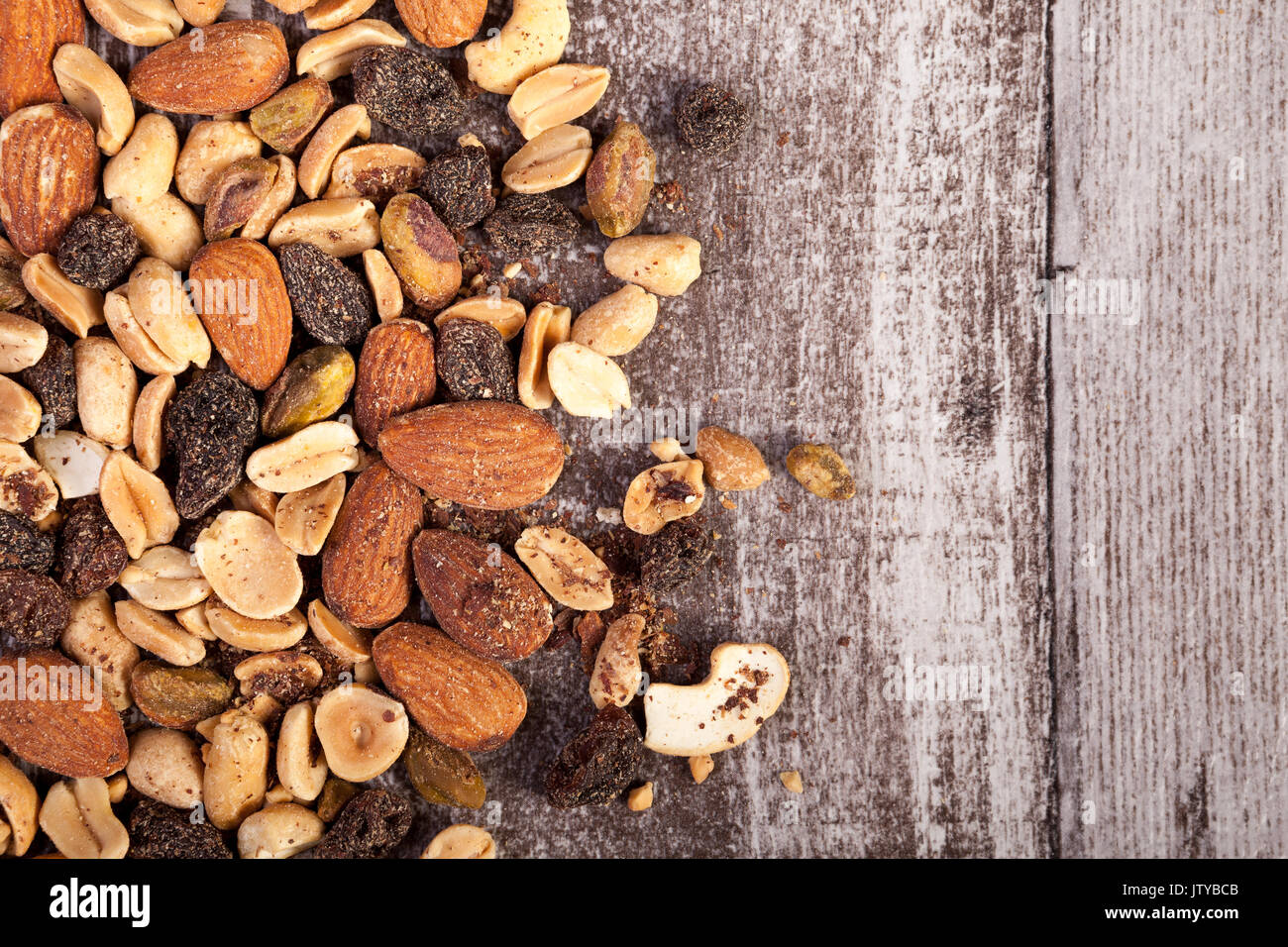 Over top view of Mix from healthy raw nuts on wooden background Stock ...
