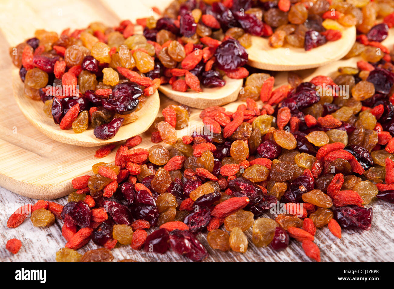 Mix of sweet dried fruits in wooden spoon Stock Photo - Alamy