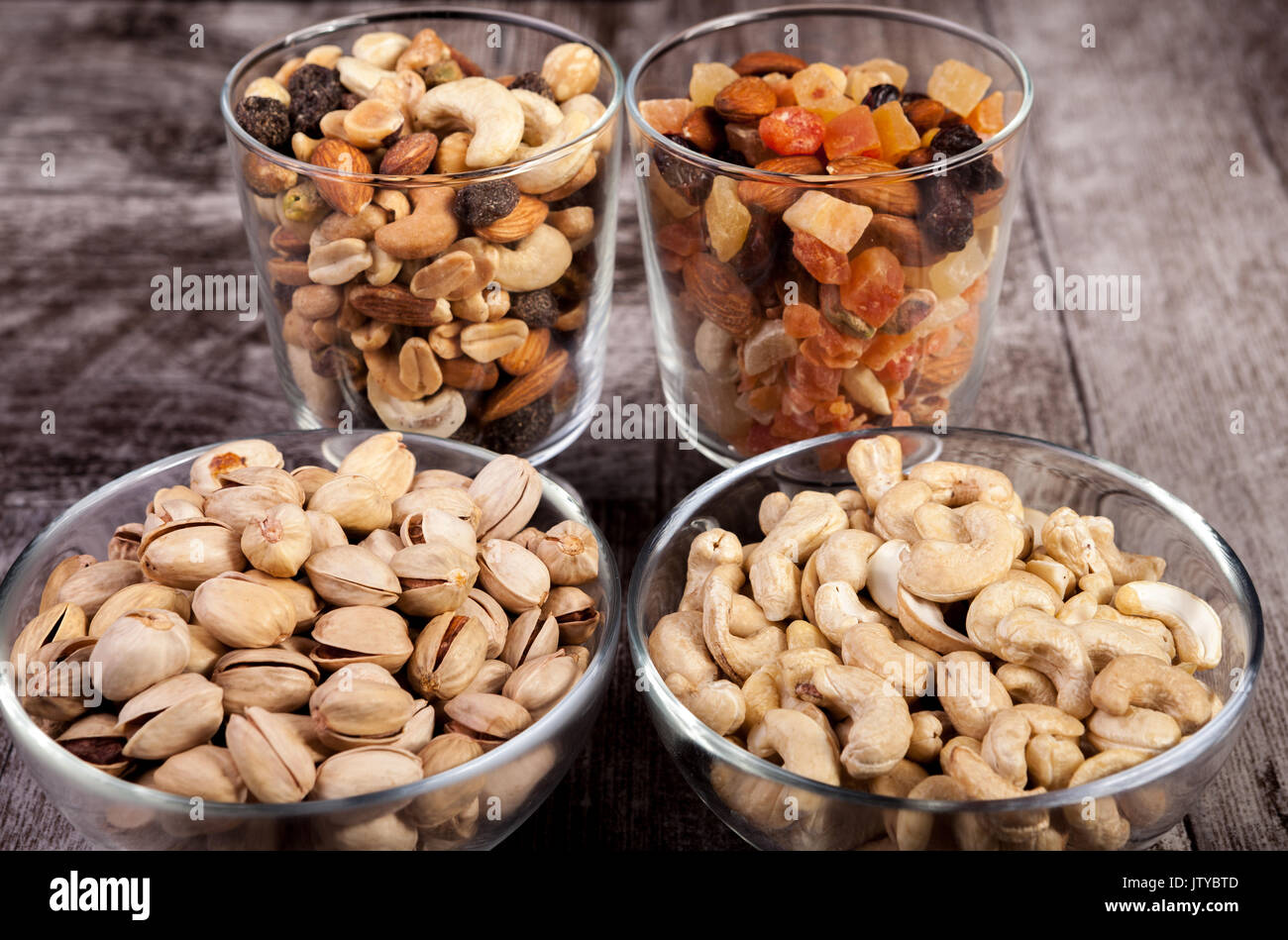 Healthy mix of dried nuts and sweets in was glass Stock Photo - Alamy