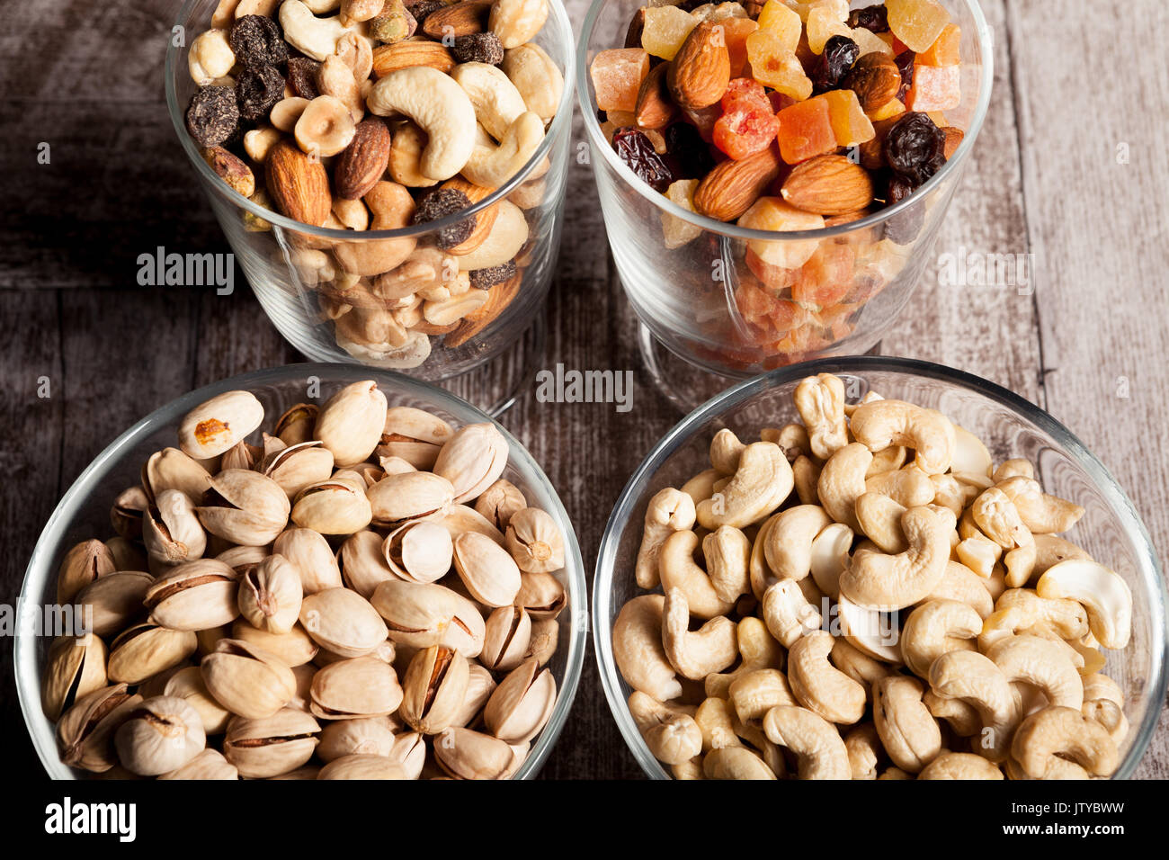 Healthy mix of dried nuts and sweets in was glass Stock Photo - Alamy