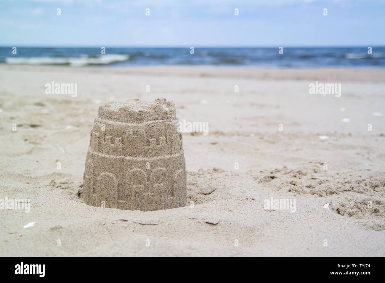 Sandy castle on on the sandy beach blurred summer background Stock ...