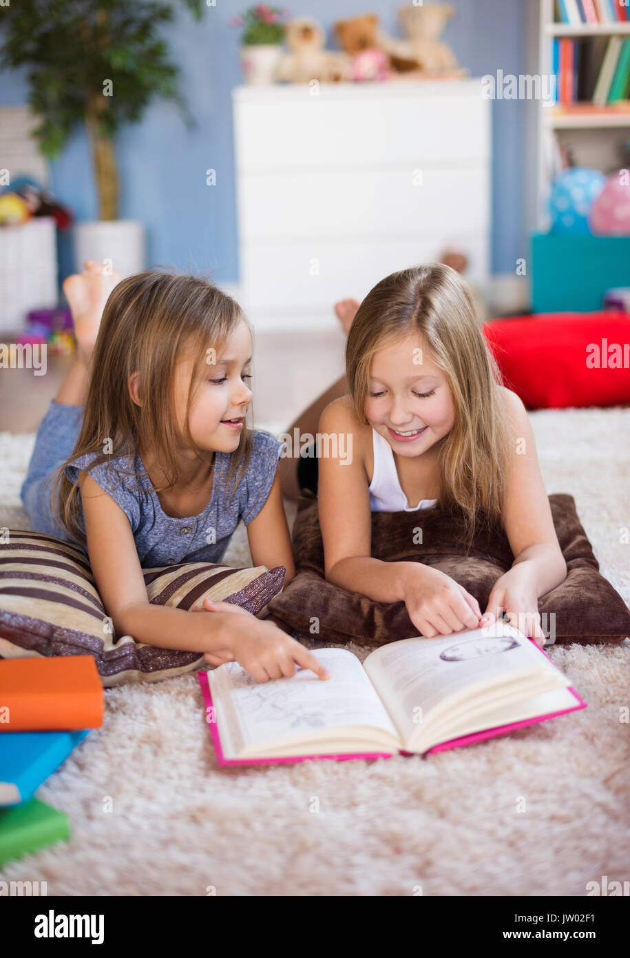 Two best friends reading an adventure book Stock Photo - Alamy